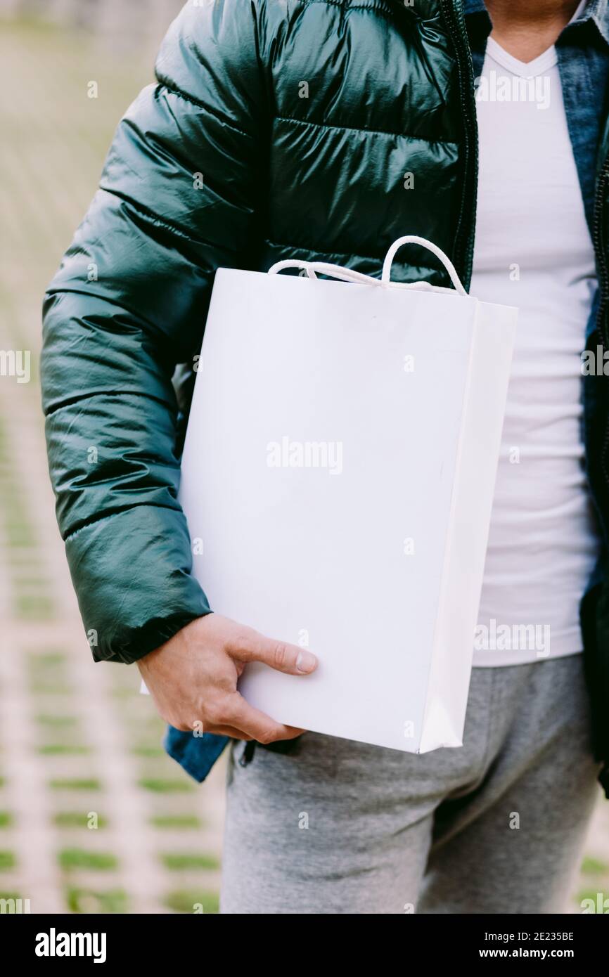 man holding White paper bag mockup Stock Photo - Alamy