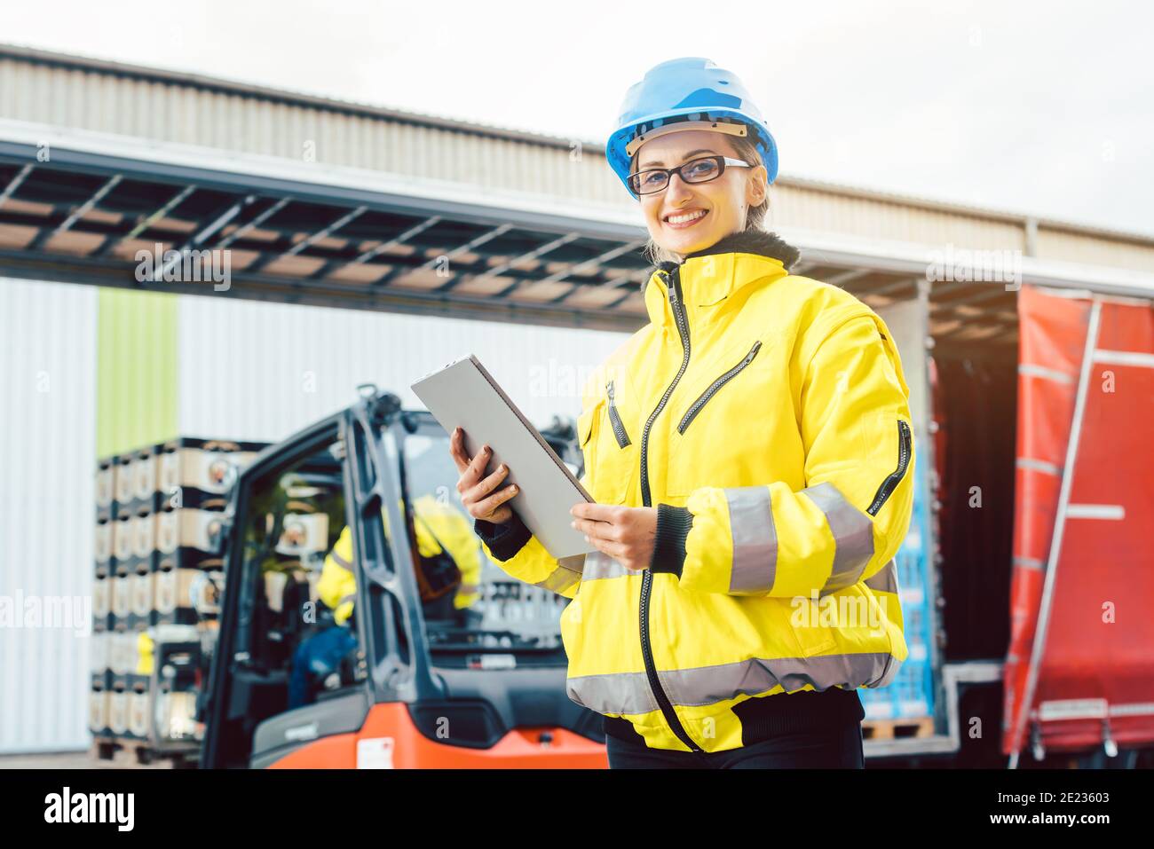 Supervisor checking contents of shipment to be sent by truck Stock ...