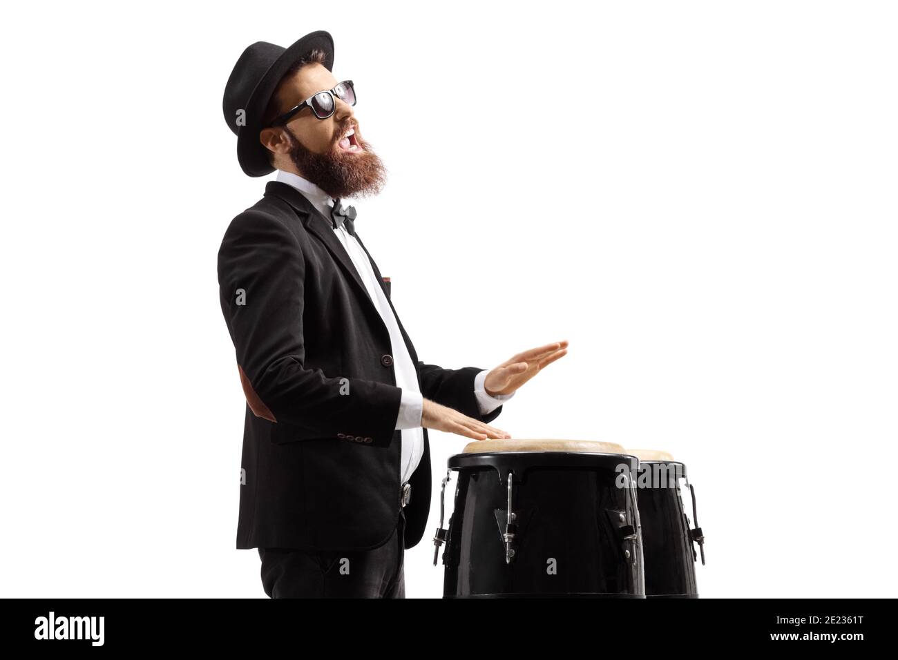 Musician in a black suit playing conga drums isolated on white ...