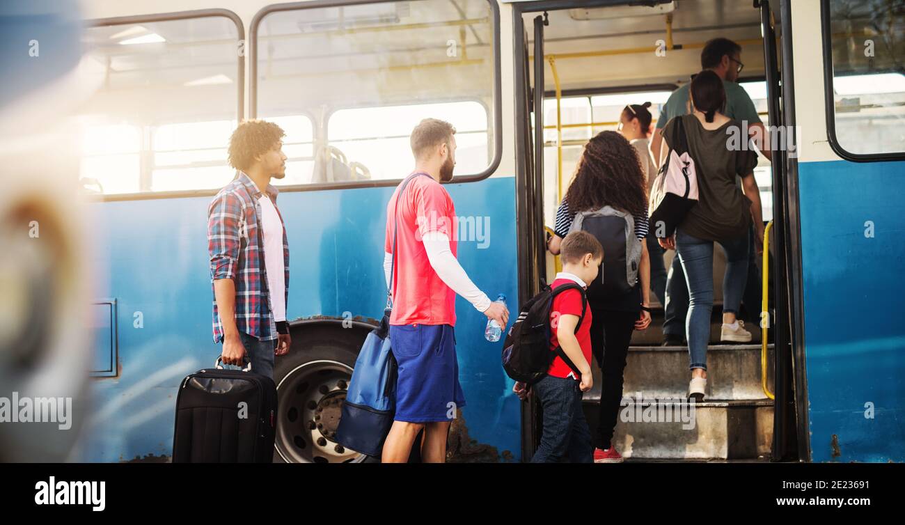 Group of people is standing in line and waiting to get in a bus Stock ...