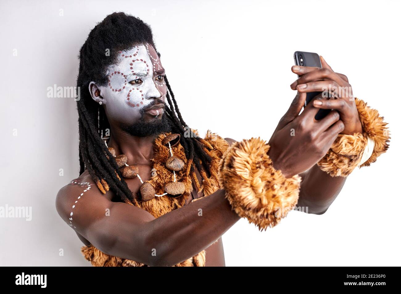 tribal man of african appearance take photo on smartphone, make selfie ...
