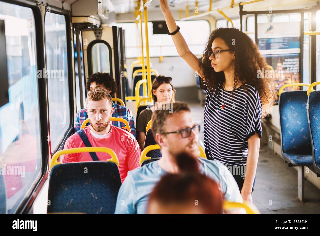 Group of people mixed age sitting and standing in a bus Stock Photo - Alamy