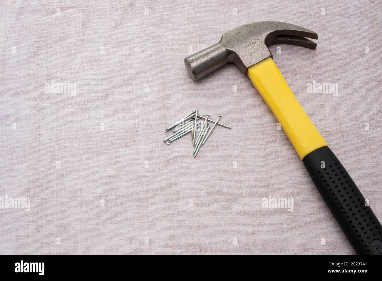 A claw hammer and some steel nails Stock Photo - Alamy