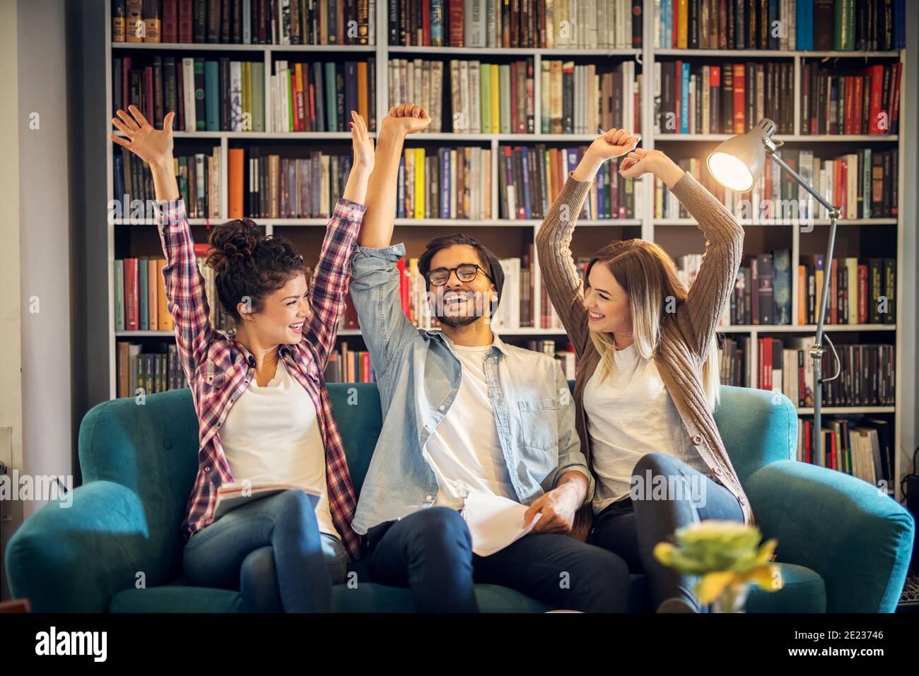 Three happy smiling students celebrating last day of school in library ...