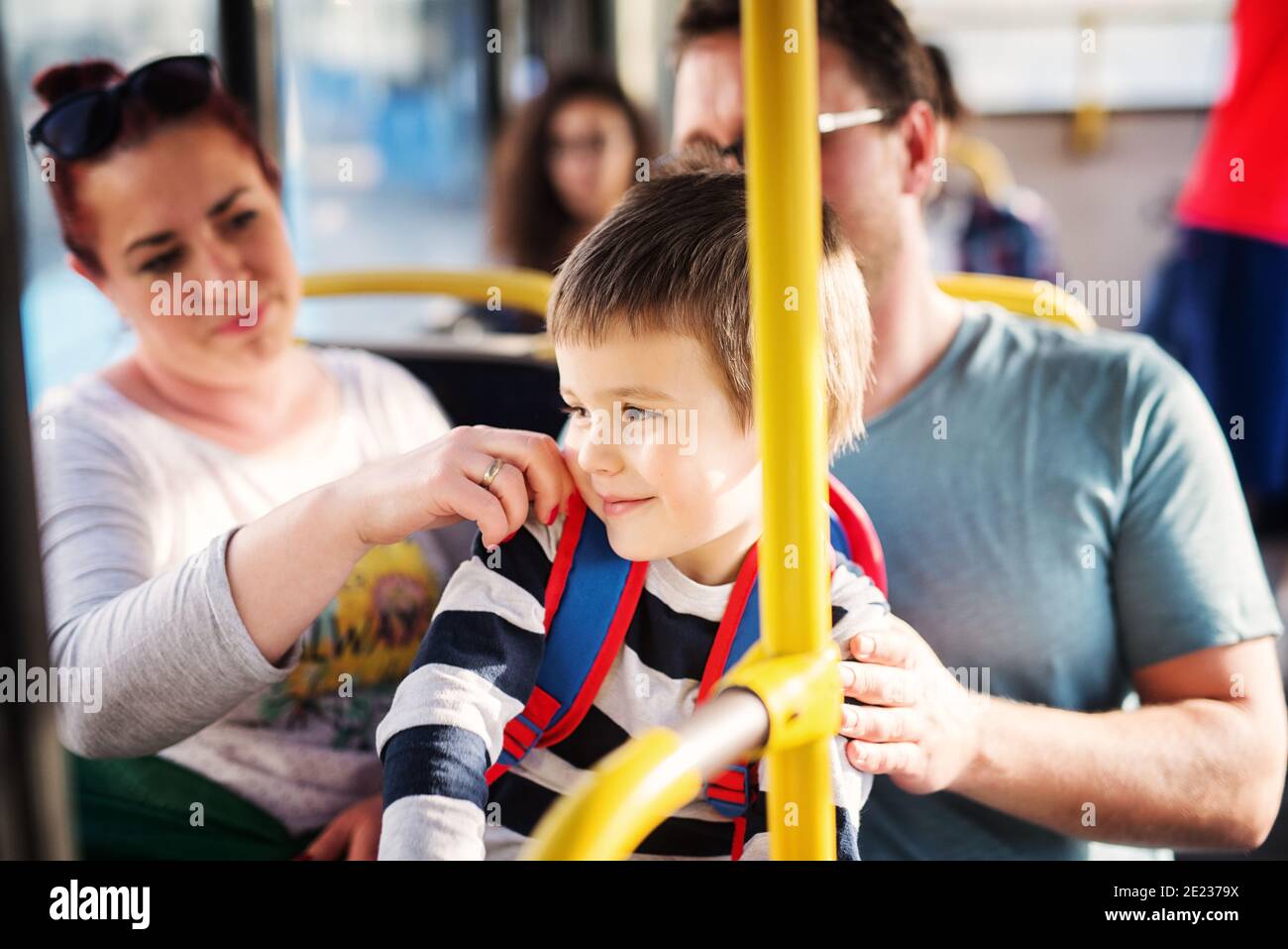 Cute shy boy is sitting in his dads lap in a bus Stock Photo - Alamy