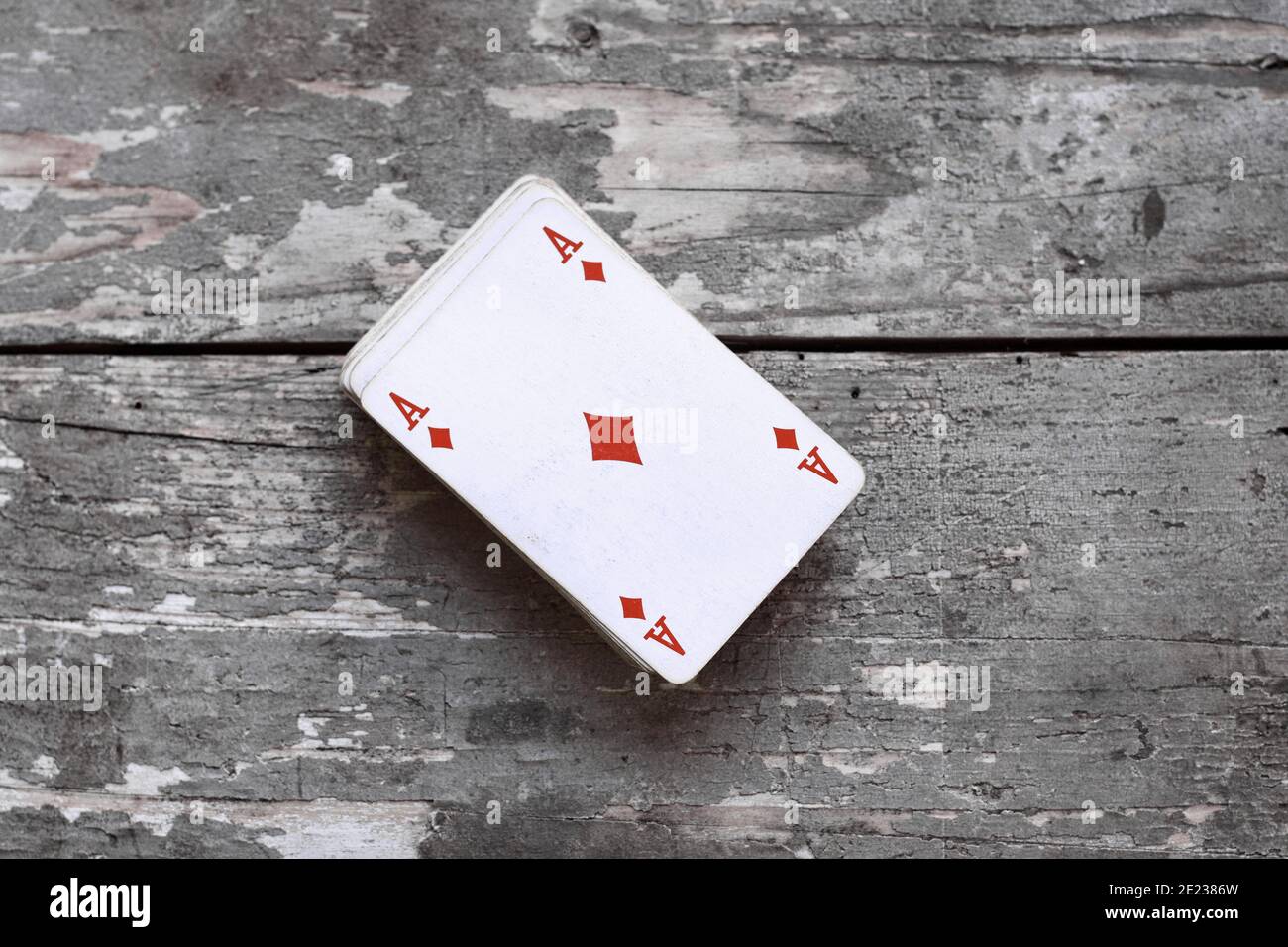 Pile of playing cards at a rustic wooden board Stock Photo - Alamy