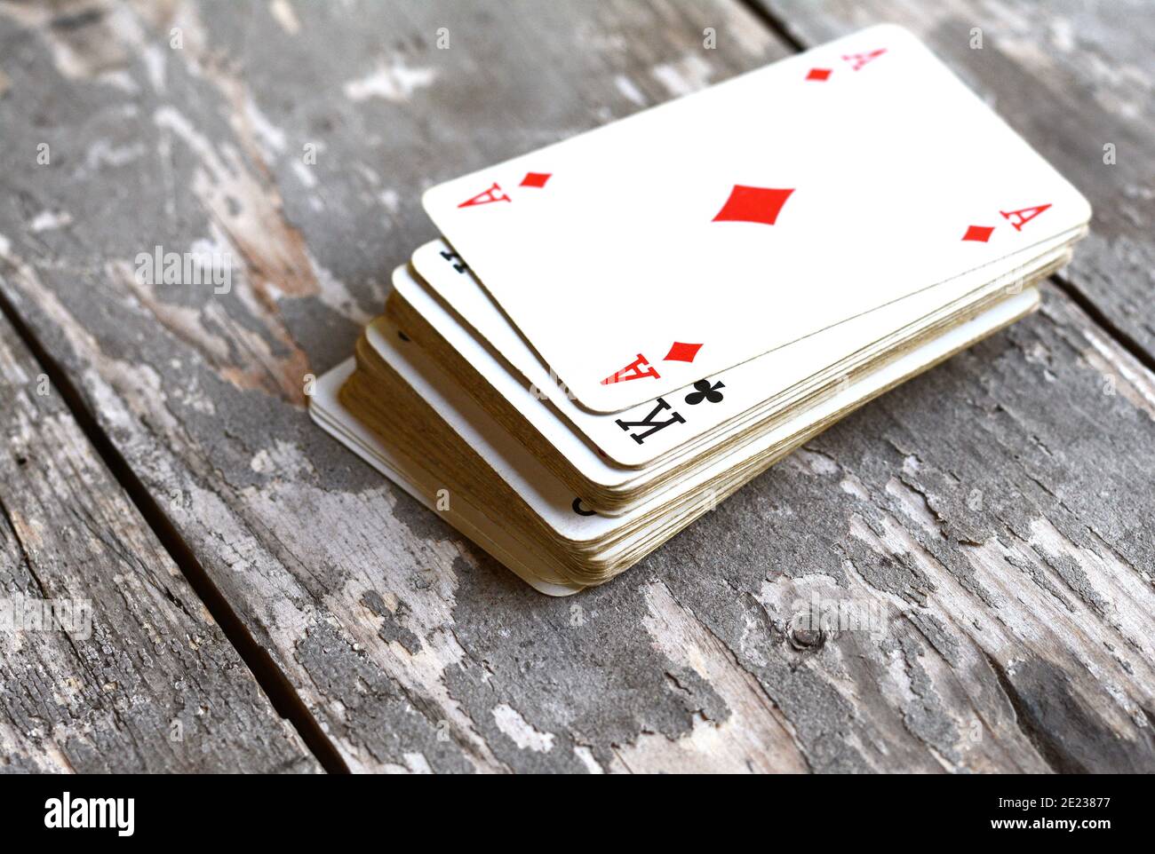 Pile of playing cards at a rustic wooden board Stock Photo - Alamy