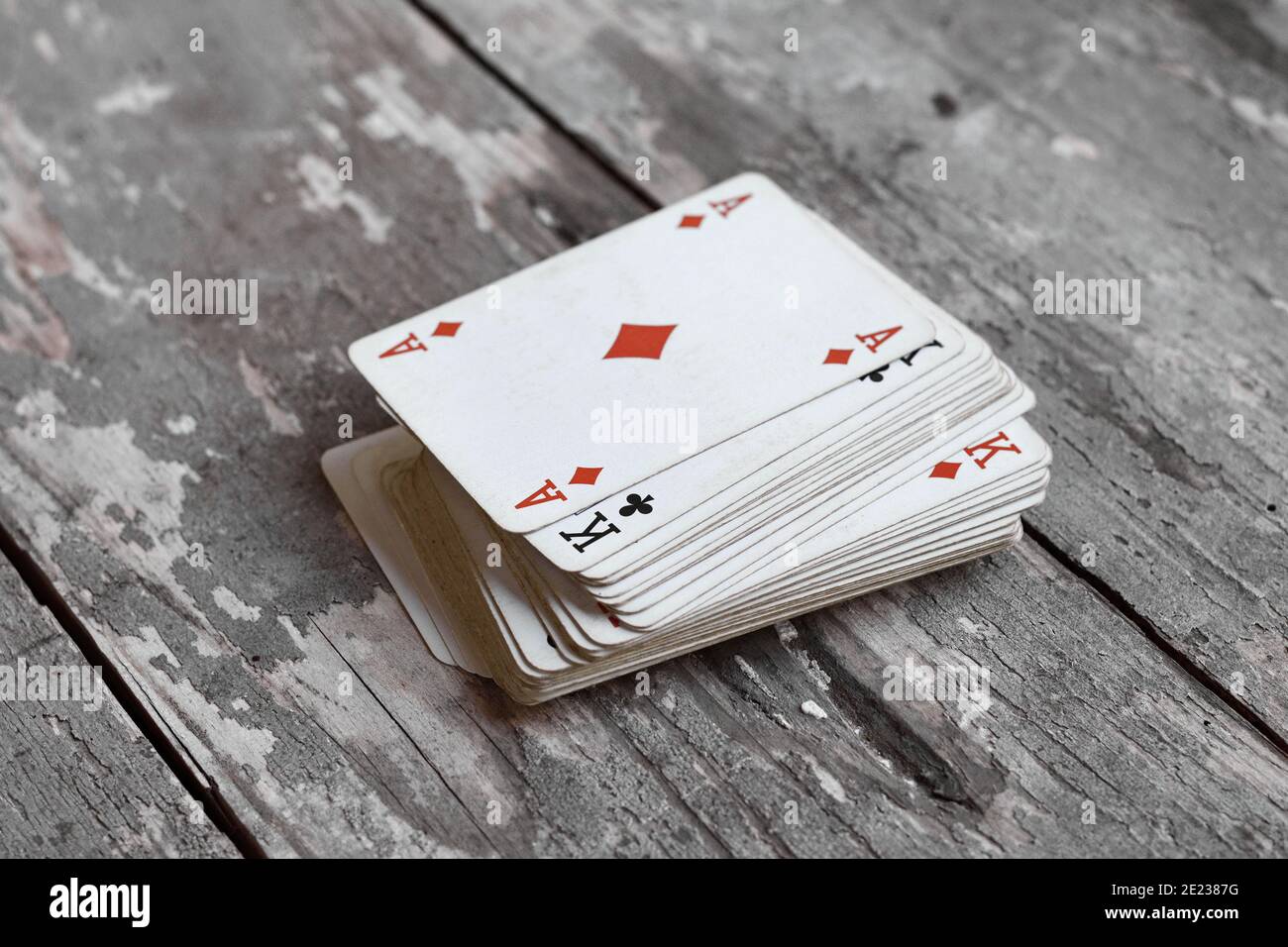 Pile of playing cards at a rustic wooden board Stock Photo - Alamy