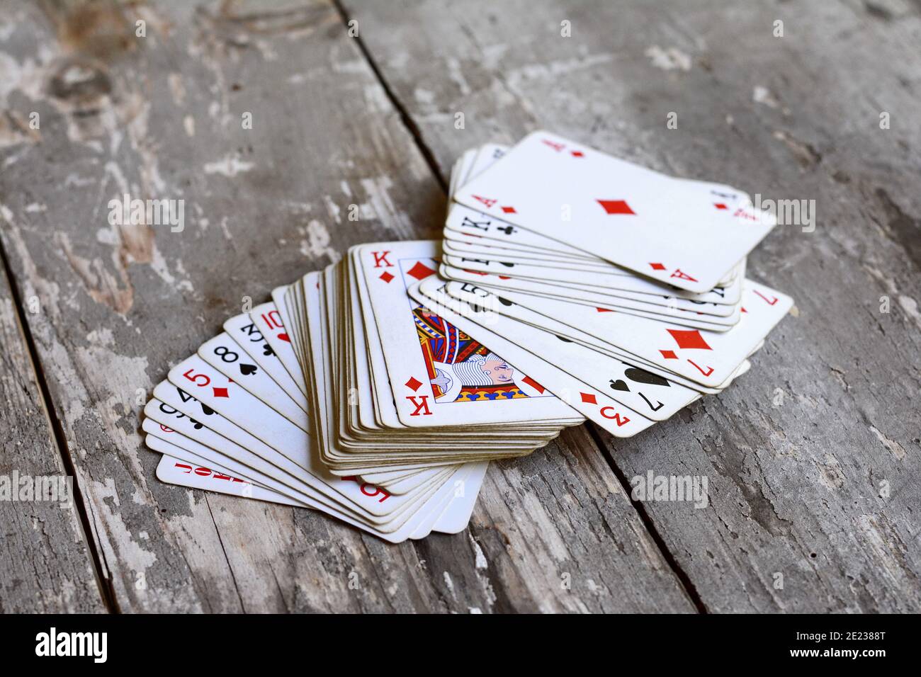 Pile of playing cards at a rustic wooden board Stock Photo - Alamy