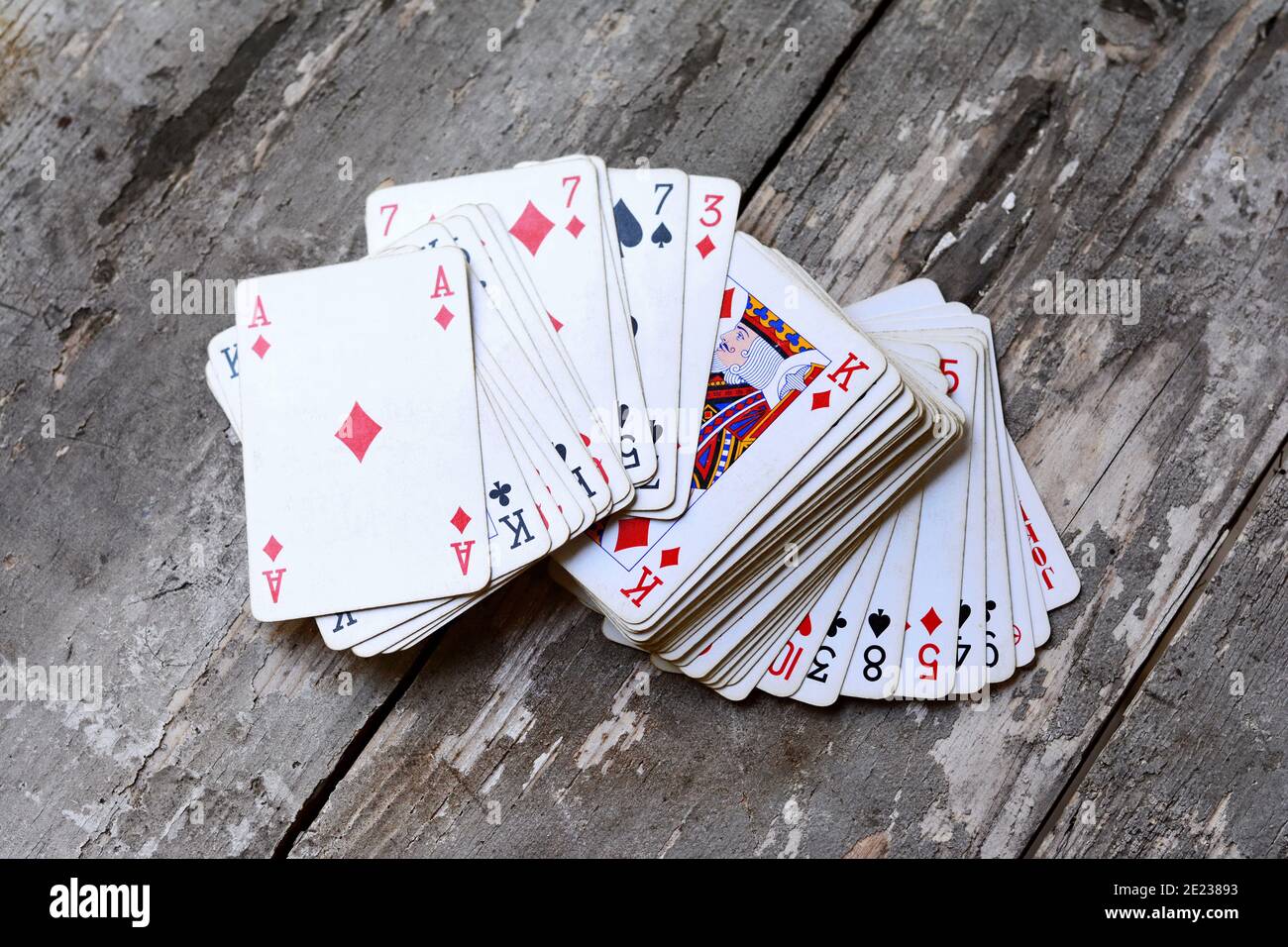 Pile of playing cards at a rustic wooden board Stock Photo - Alamy