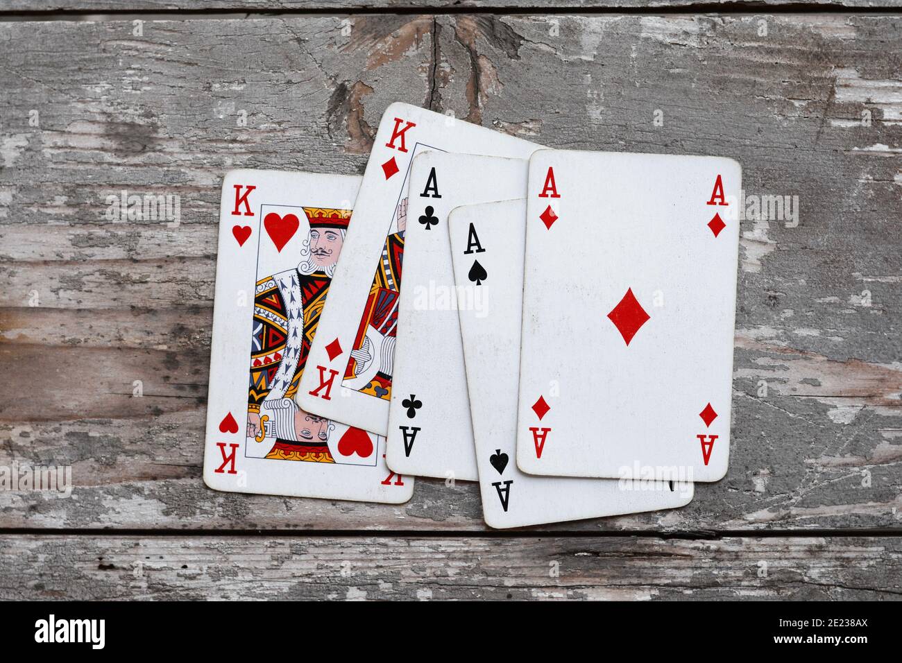 Pile of playing cards at a rustic wooden board Stock Photo - Alamy