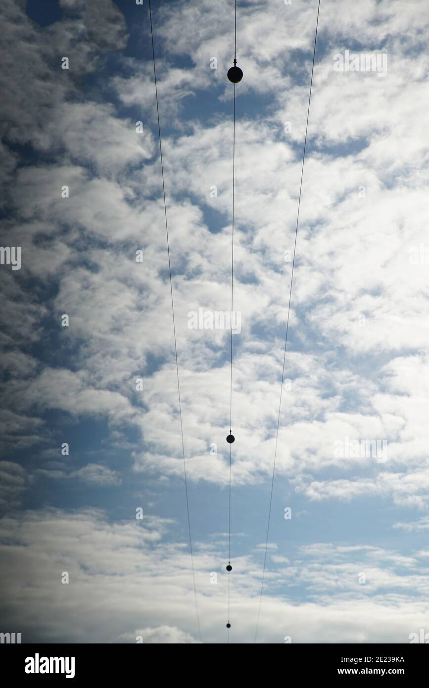 Beautiful shot of a cloudy sky with electrical cables in a daytime ...