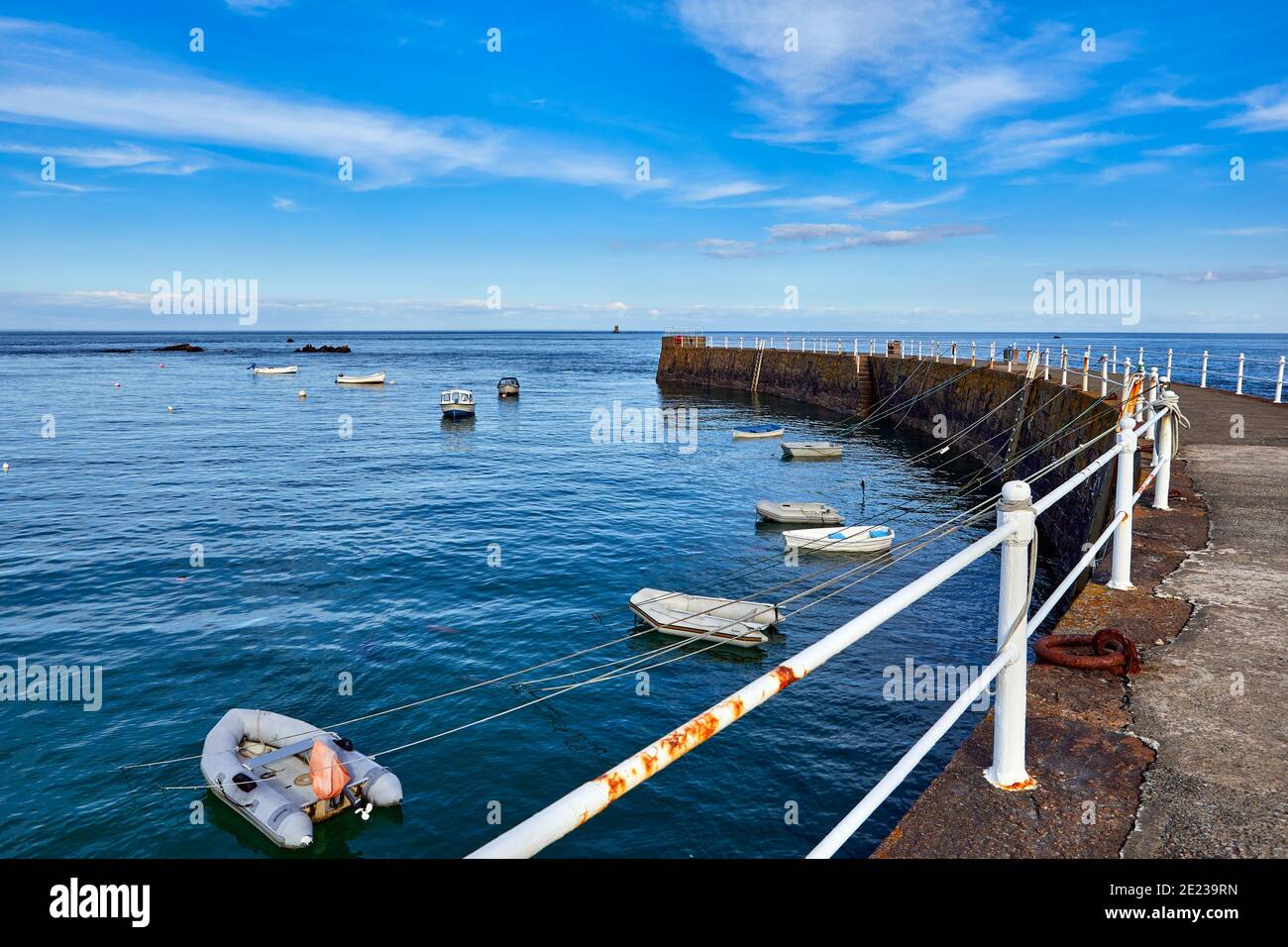 Image of La Rocque harbour pier with boats blue sky with some clouds ...