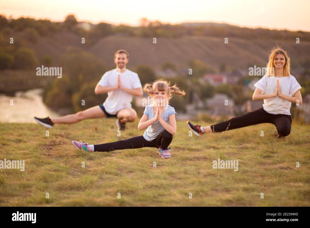 Happy healthy active family of three do gymnastic exercises together ...
