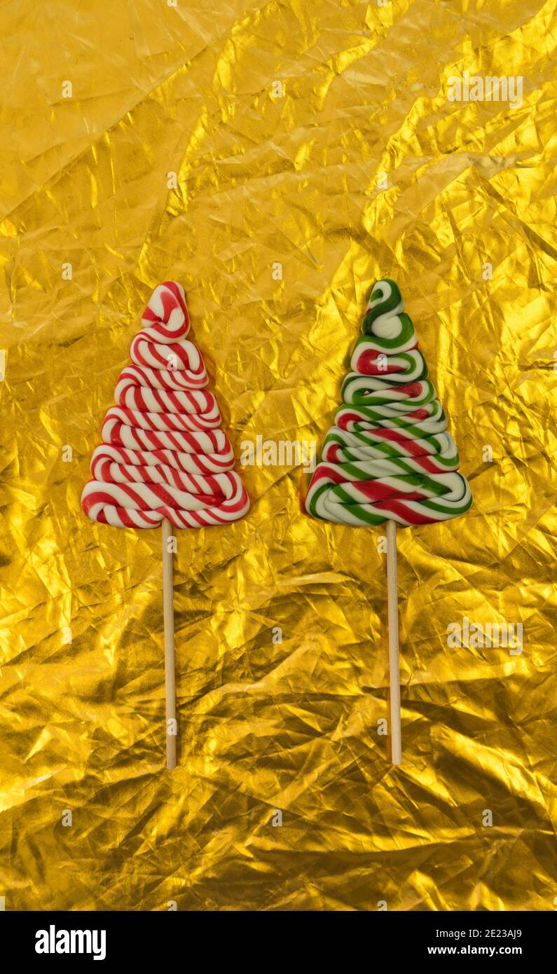 Christmas candy on a stick. Striped candies in the form of a Christmas ...