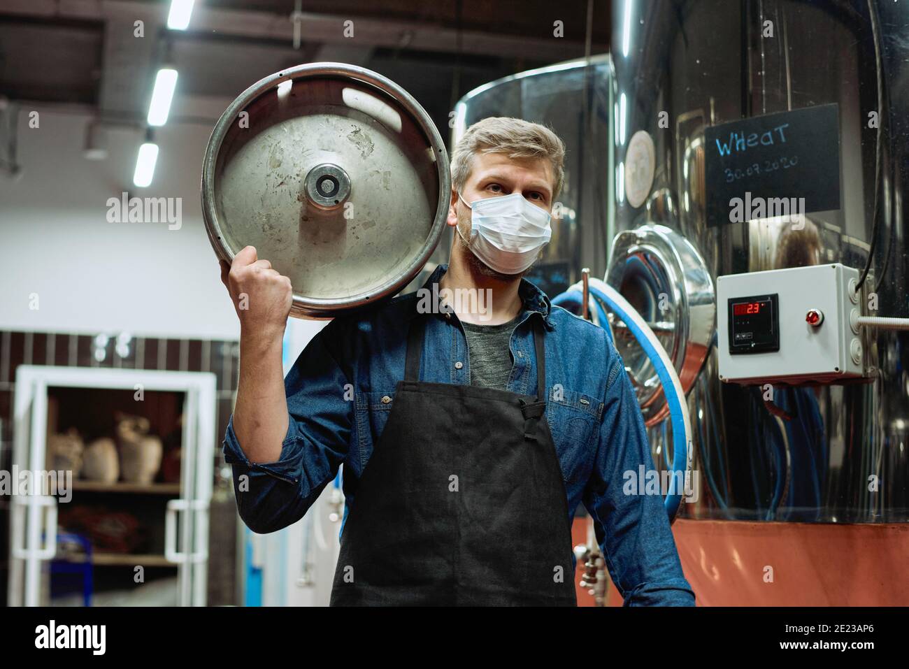Male worker of contemporary beer production plant in workwear and ...