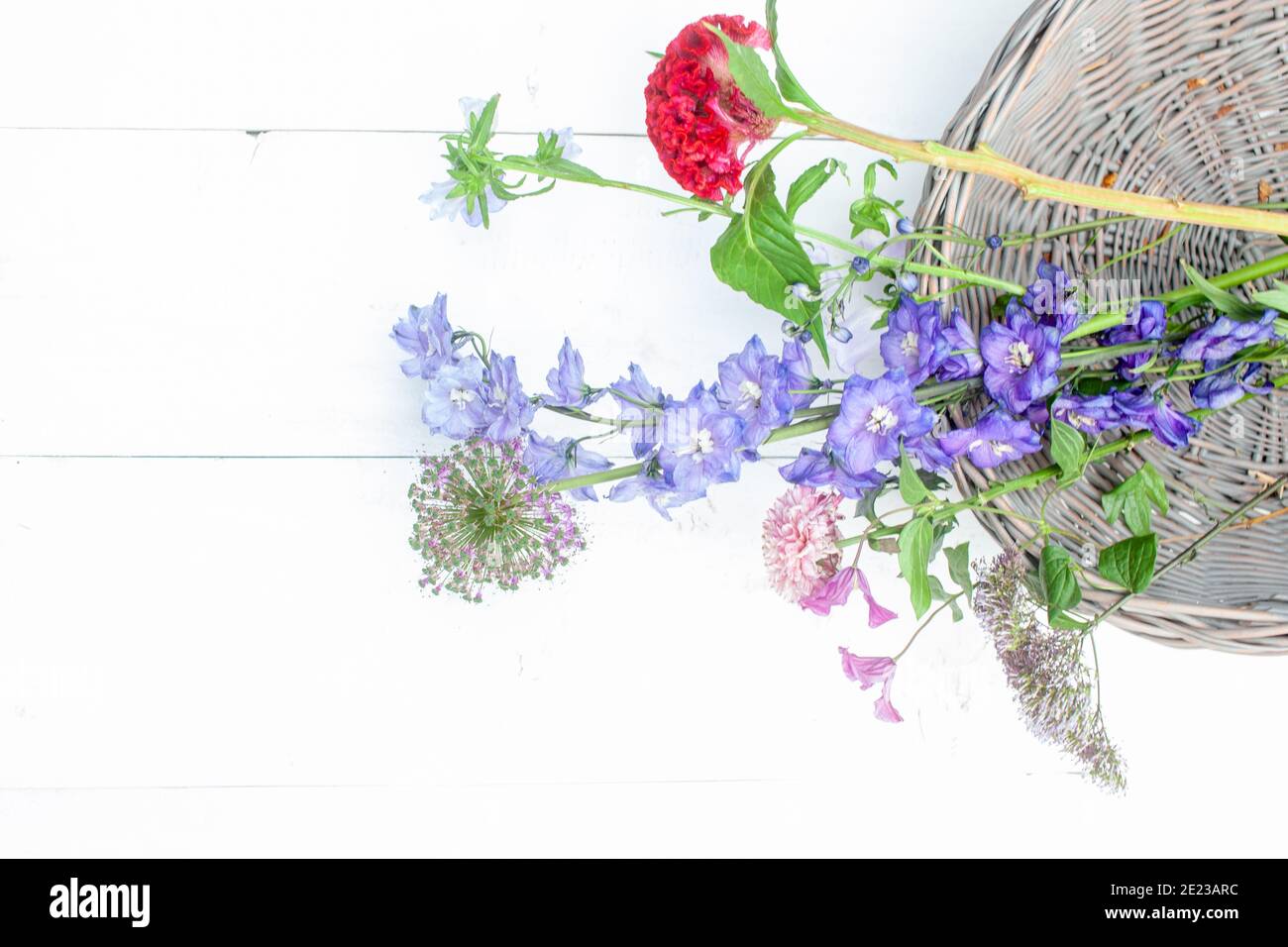 bouquet of dry flowers and potpourri in a Wood plate on a white table ...