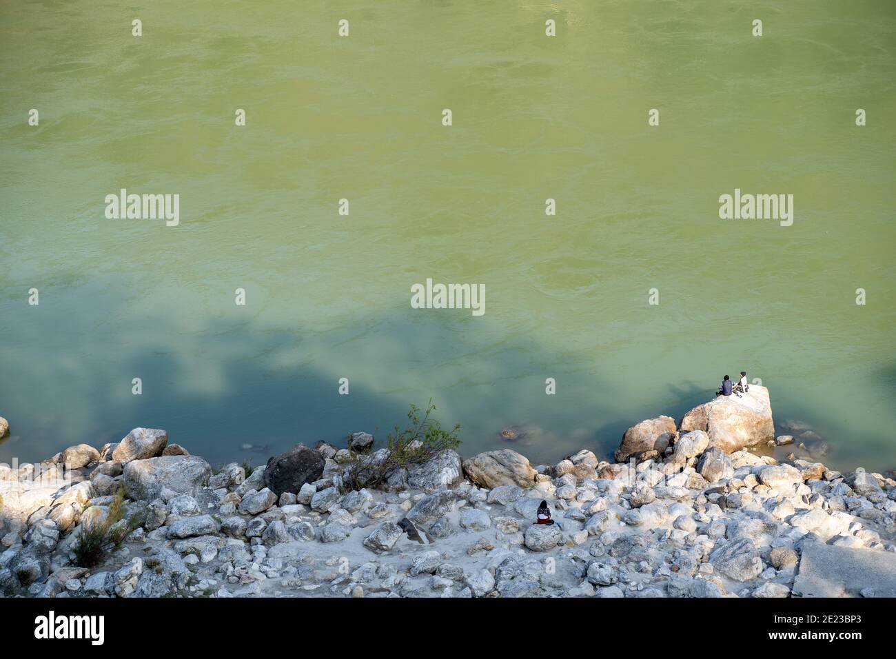 Rishikesh, India - Feburary 22, 2020: Two Indian men sit on a large ...
