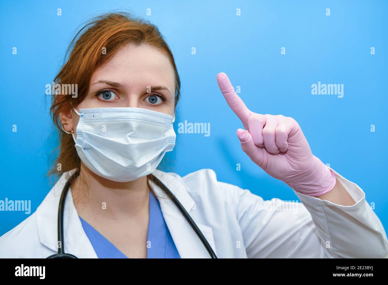 The doctor makes a careful finger - up gesture, close-up. A woman in ...