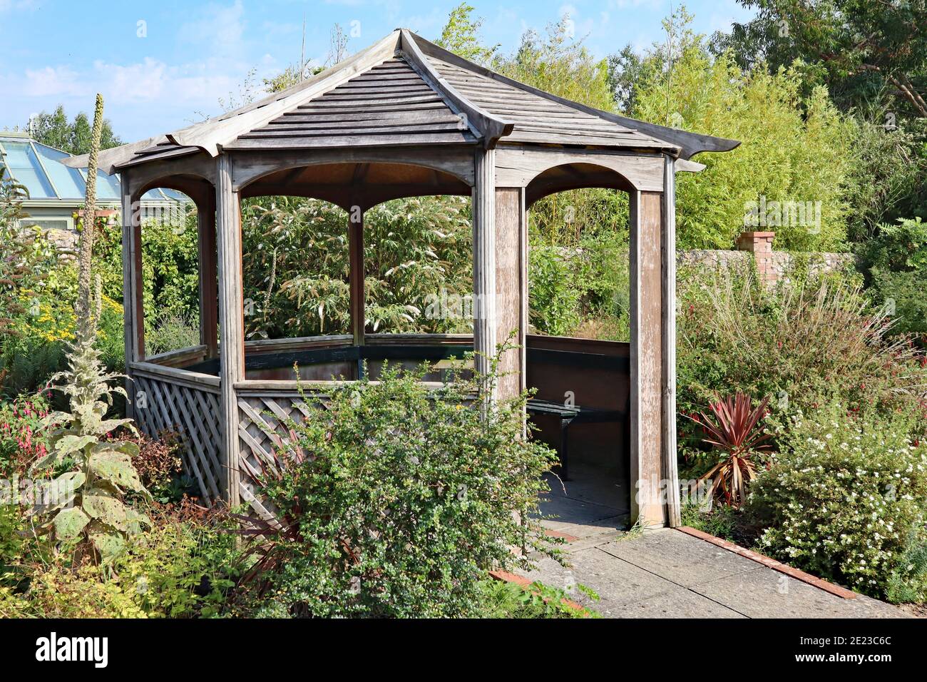 A small hexagonal gazebo in small public park by the river Coly in ...