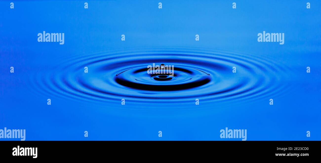 Circular waves on the surface of the blue water Stock Photo - Alamy