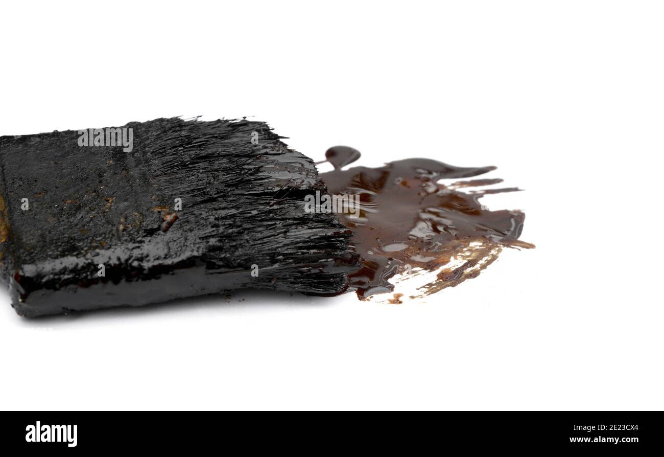 Dark brush and tar puddle isolated on white background Stock Photo - Alamy