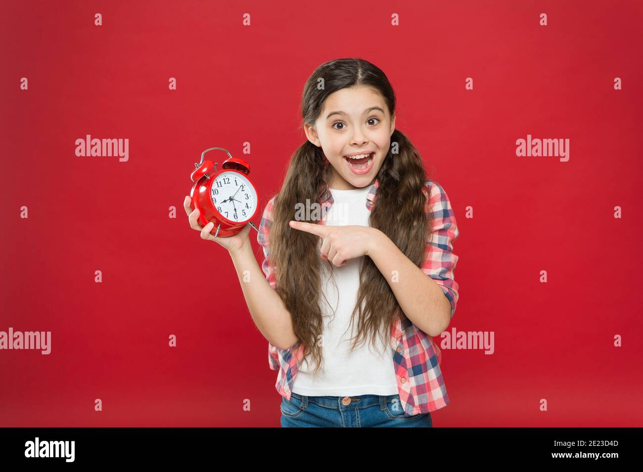 just look at that. teen kid showing time on clock. girl pointing finger ...