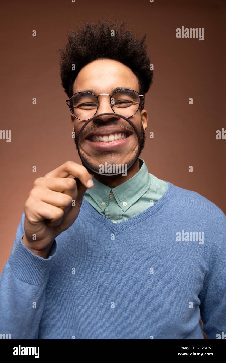 Funny young mixed-race businessman in eyeglasses and smart casualwear ...