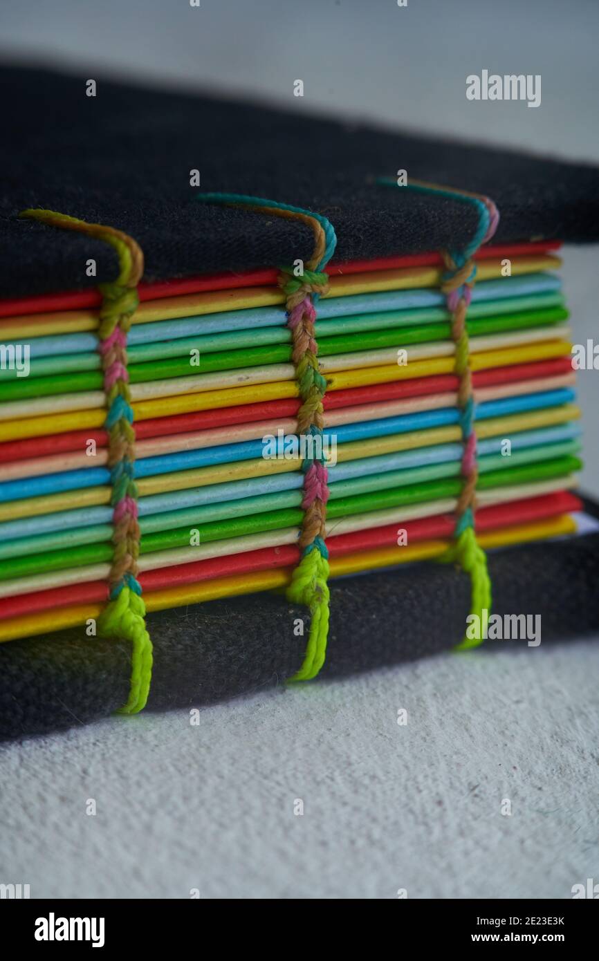 Closeup shot of a book with colorful paper bound with woven thread ...