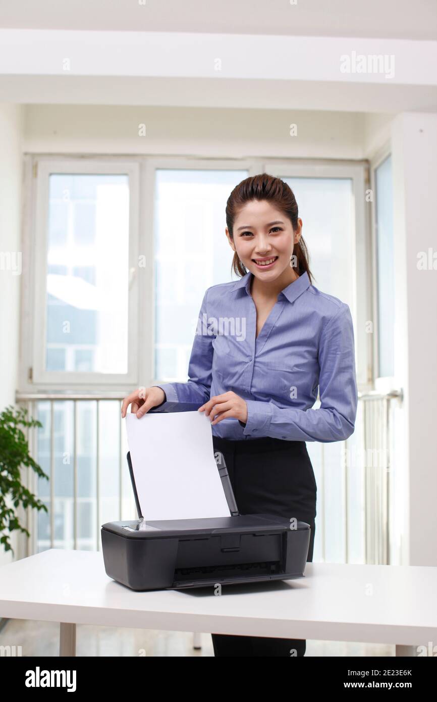 A Business woman with printer in office high quality photo Stock Photo ...