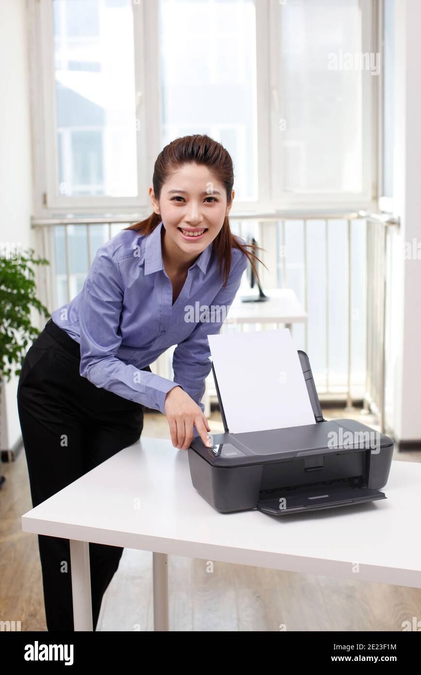 A Business woman with printer in office high quality photo Stock Photo ...