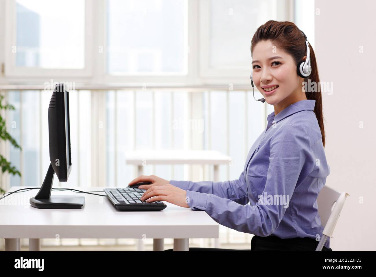 A Business woman with headset using computer high quality photo Stock ...