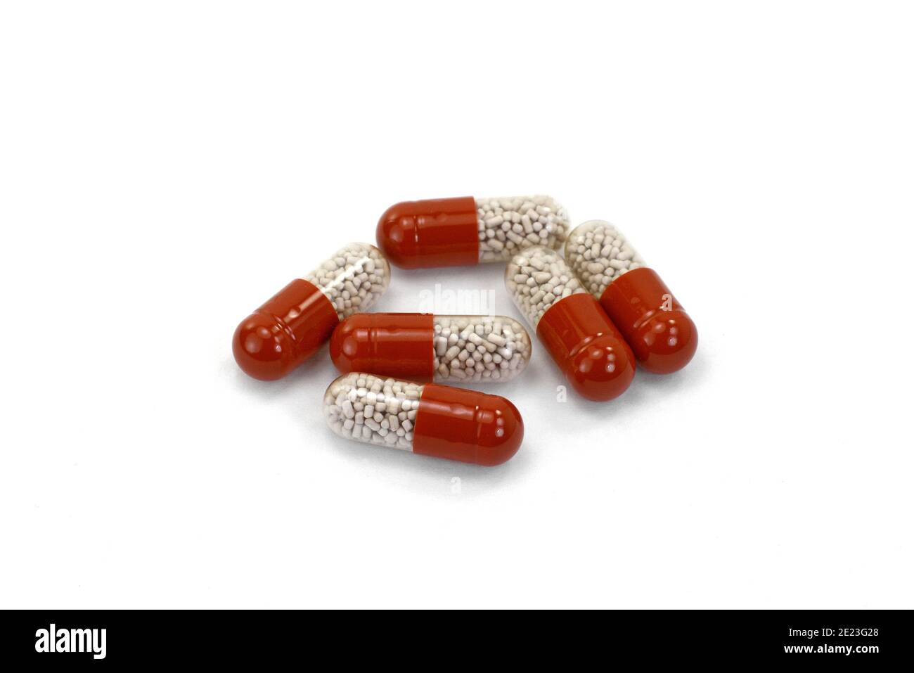 red transparent capsule on white background Stock Photo - Alamy