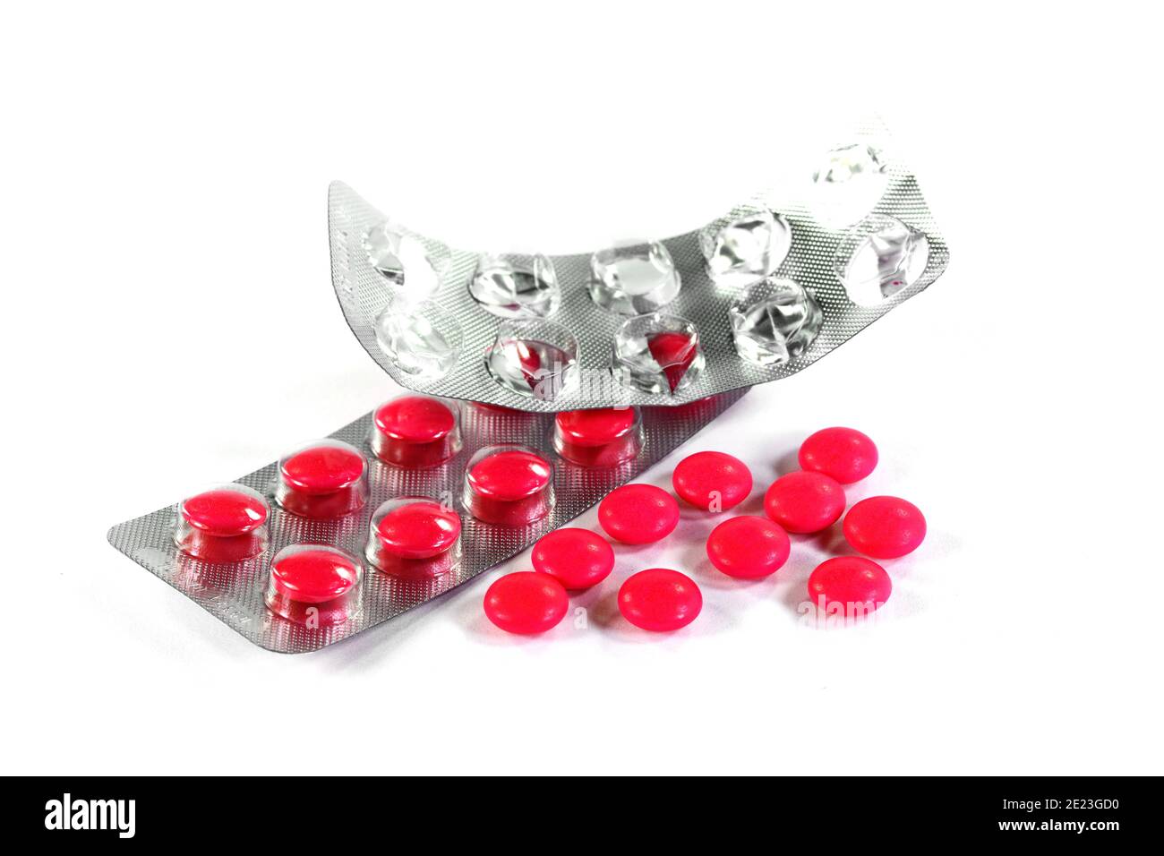 Red pills on white background Stock Photo - Alamy