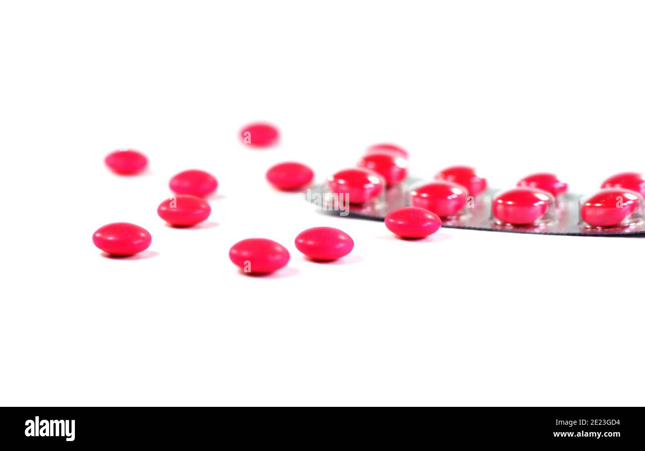 Red pills on white background Stock Photo - Alamy