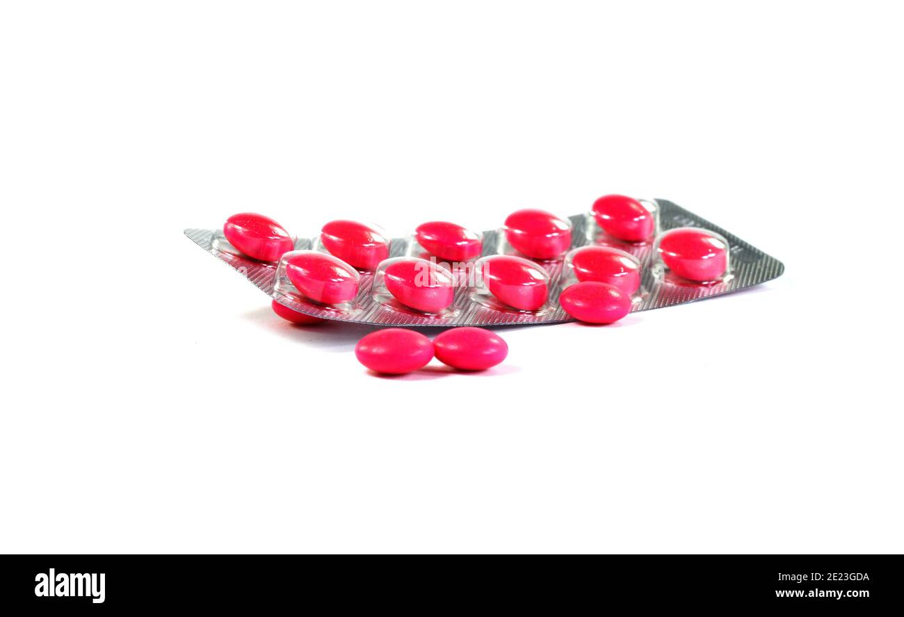 Red pills on white background Stock Photo - Alamy