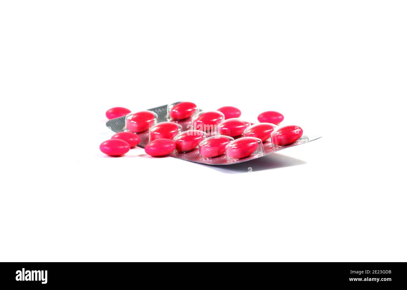 Red pills on white background Stock Photo - Alamy
