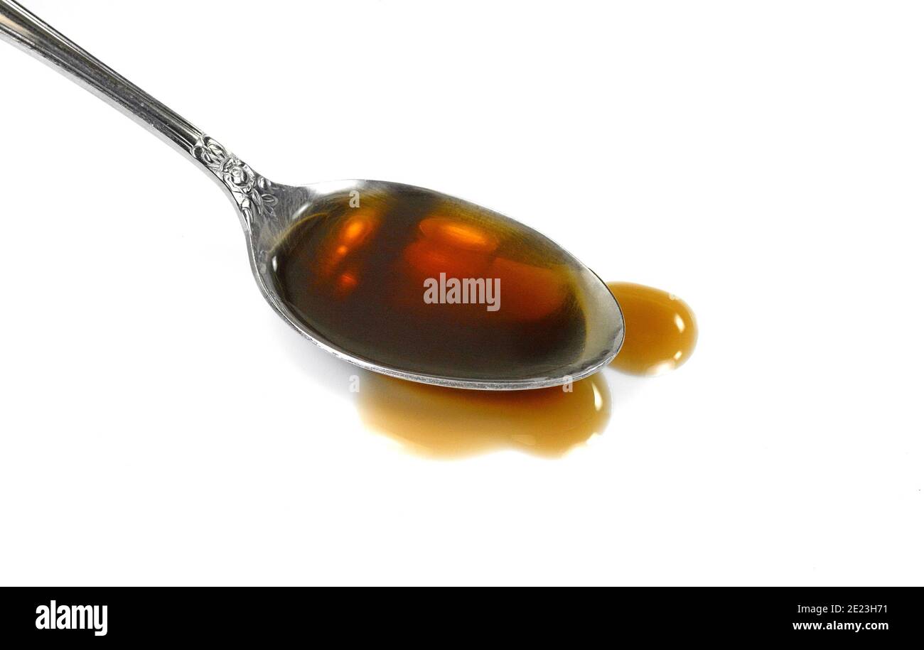 Spoonful of Cough Medicine isolated on a white background. medication ...