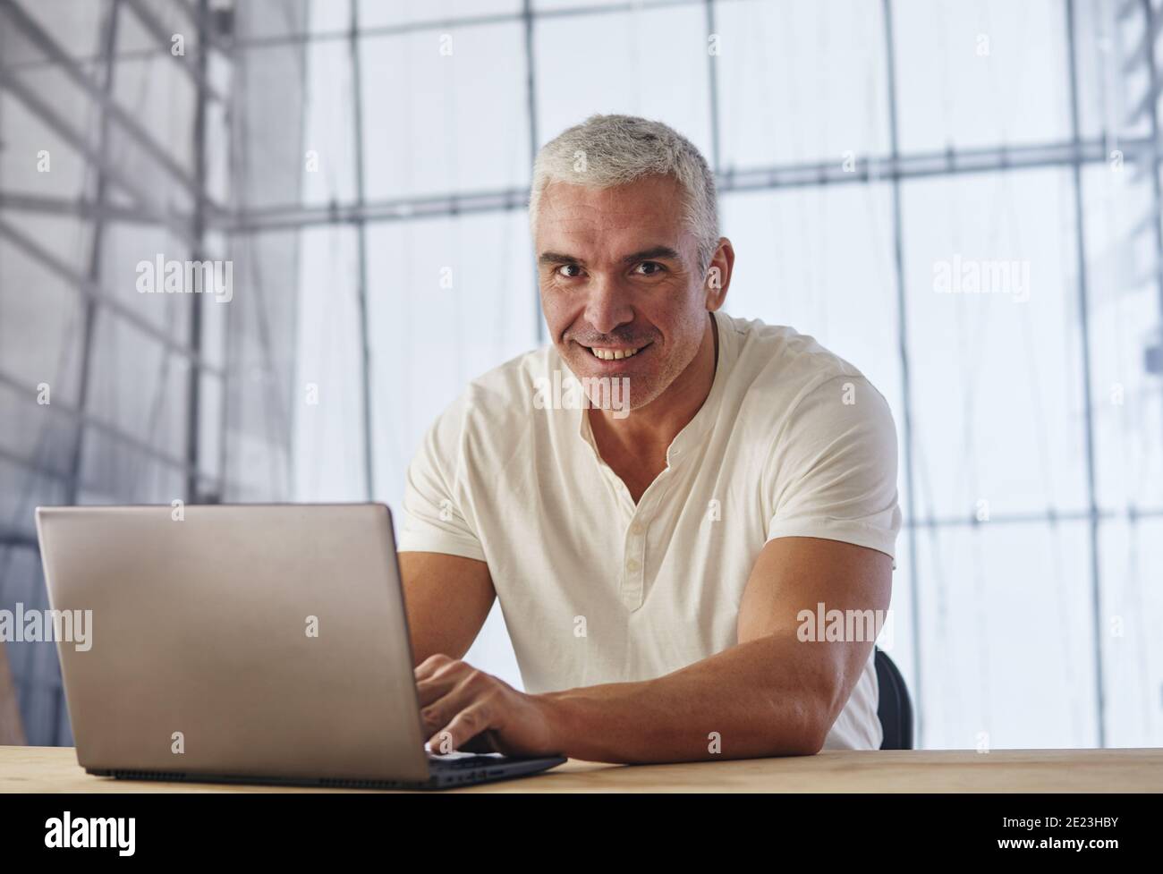 Attractive middle aged businessman standing hi-res stock photography ...