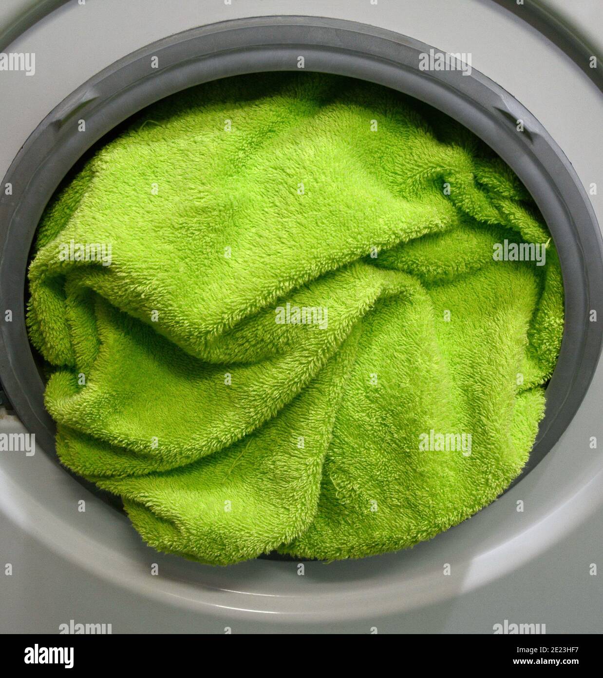 A close up of a washing machine loaded with clothes Stock Photo - Alamy
