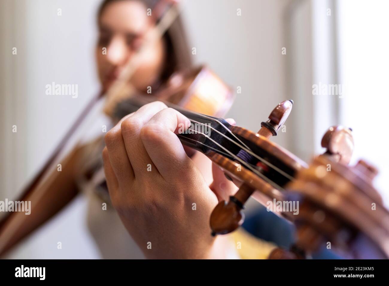 Musician girl playing a viola, focus on the strings Stock Photo - Alamy