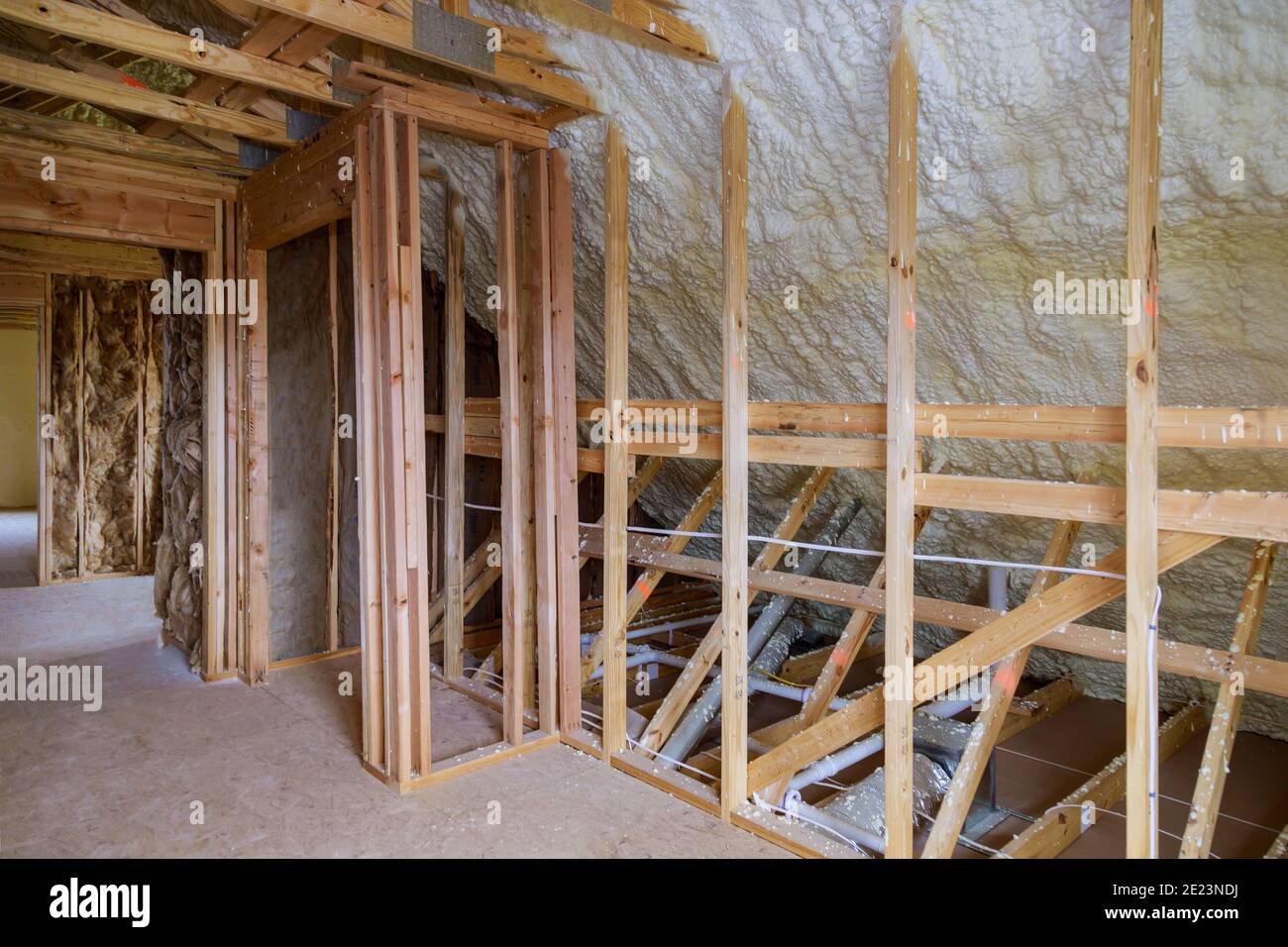 Foam plastic insulation installed in the sloping attic of a new frame ...