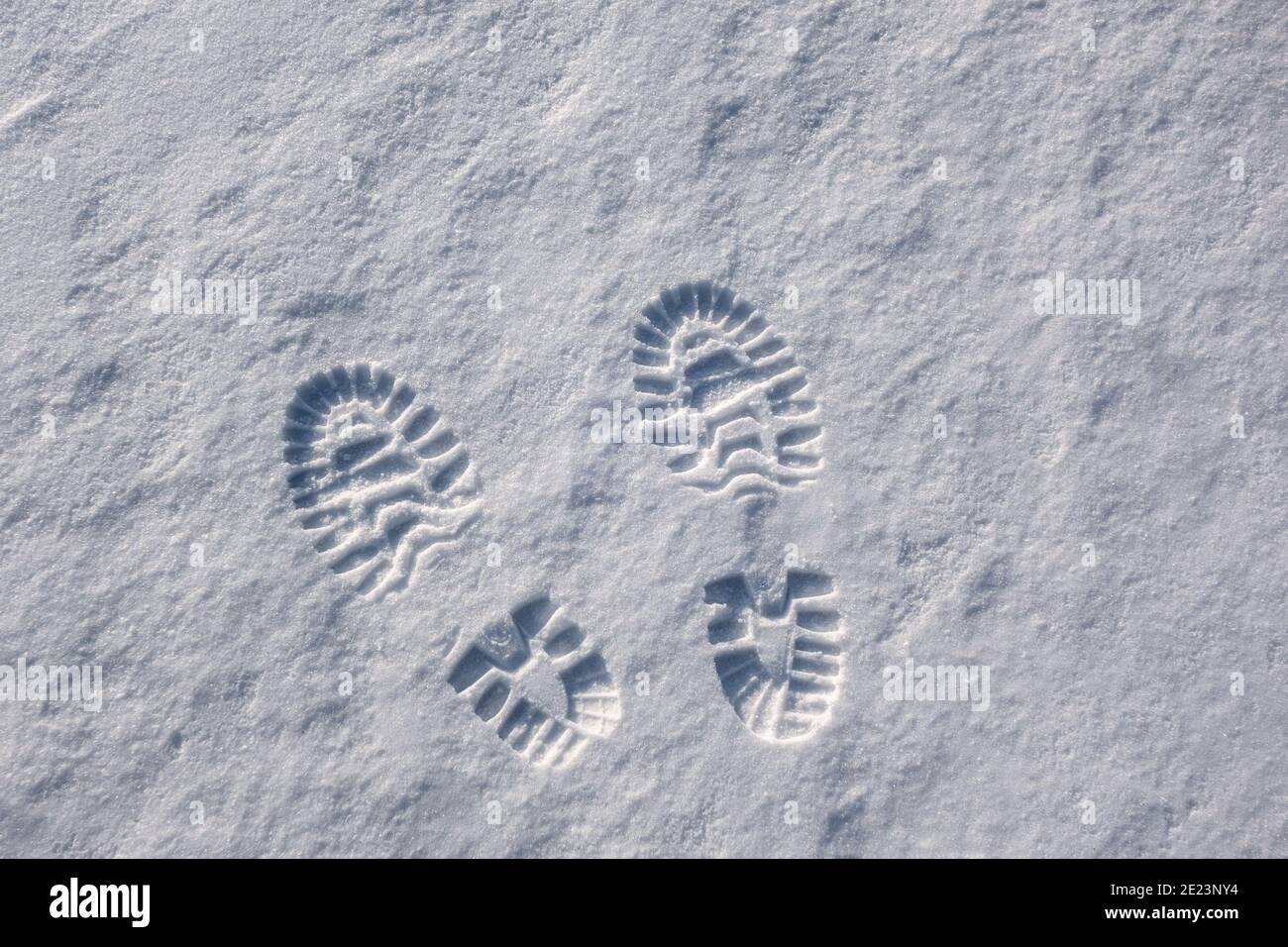 Shoe print in the snow. Clear footprints on white freshly fallen snow ...