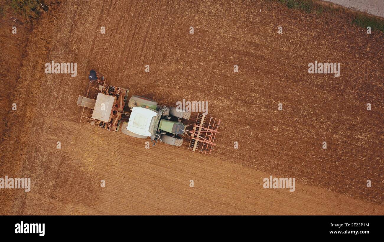 Aerial top view of a combine harvester preparing an agricultural land ...