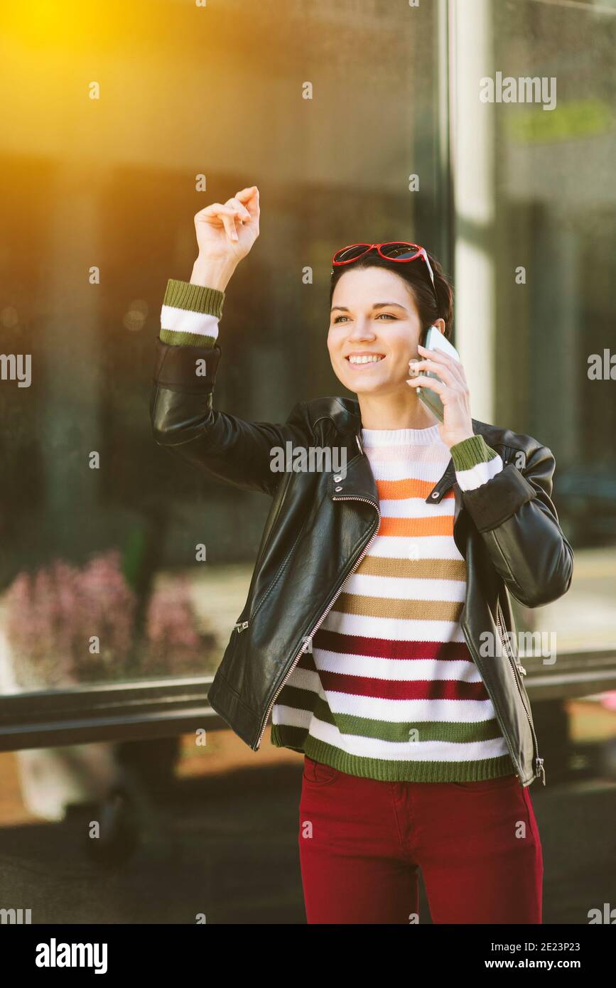Woman gestures with her hand with a big smile - Outdoors - Smart Phone ...