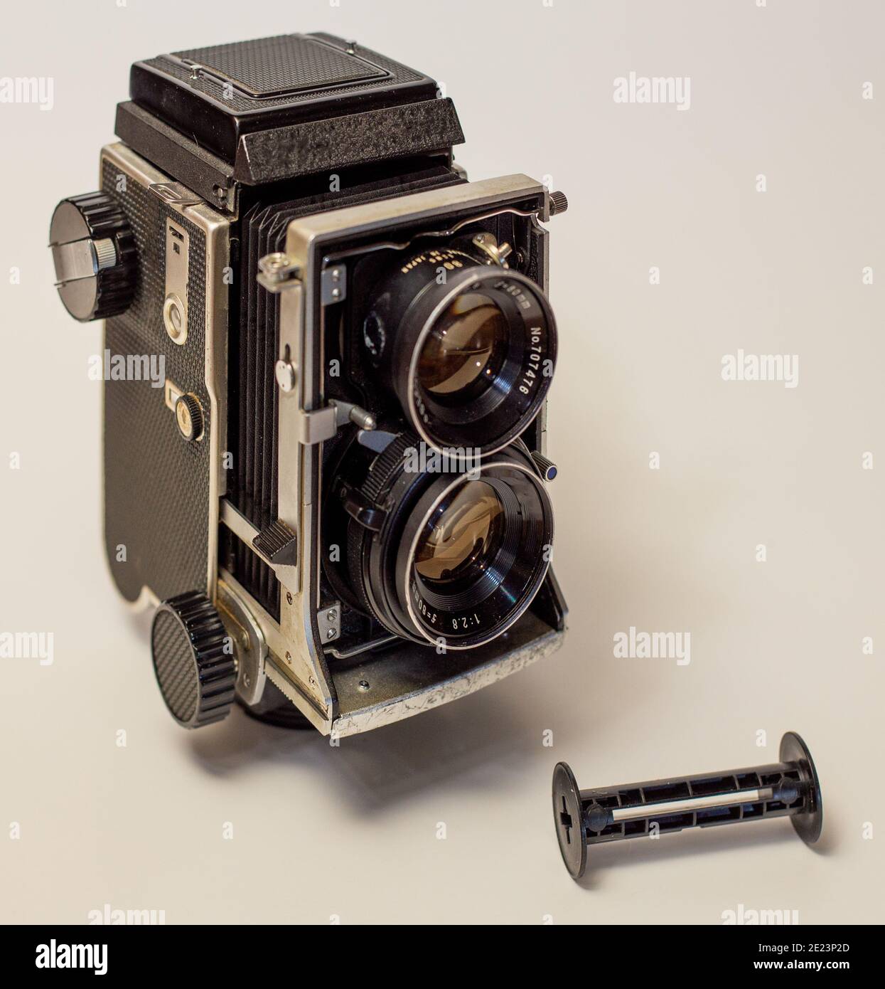 Old vintage twin-lens reflex roll-film camera isolated on a white ...