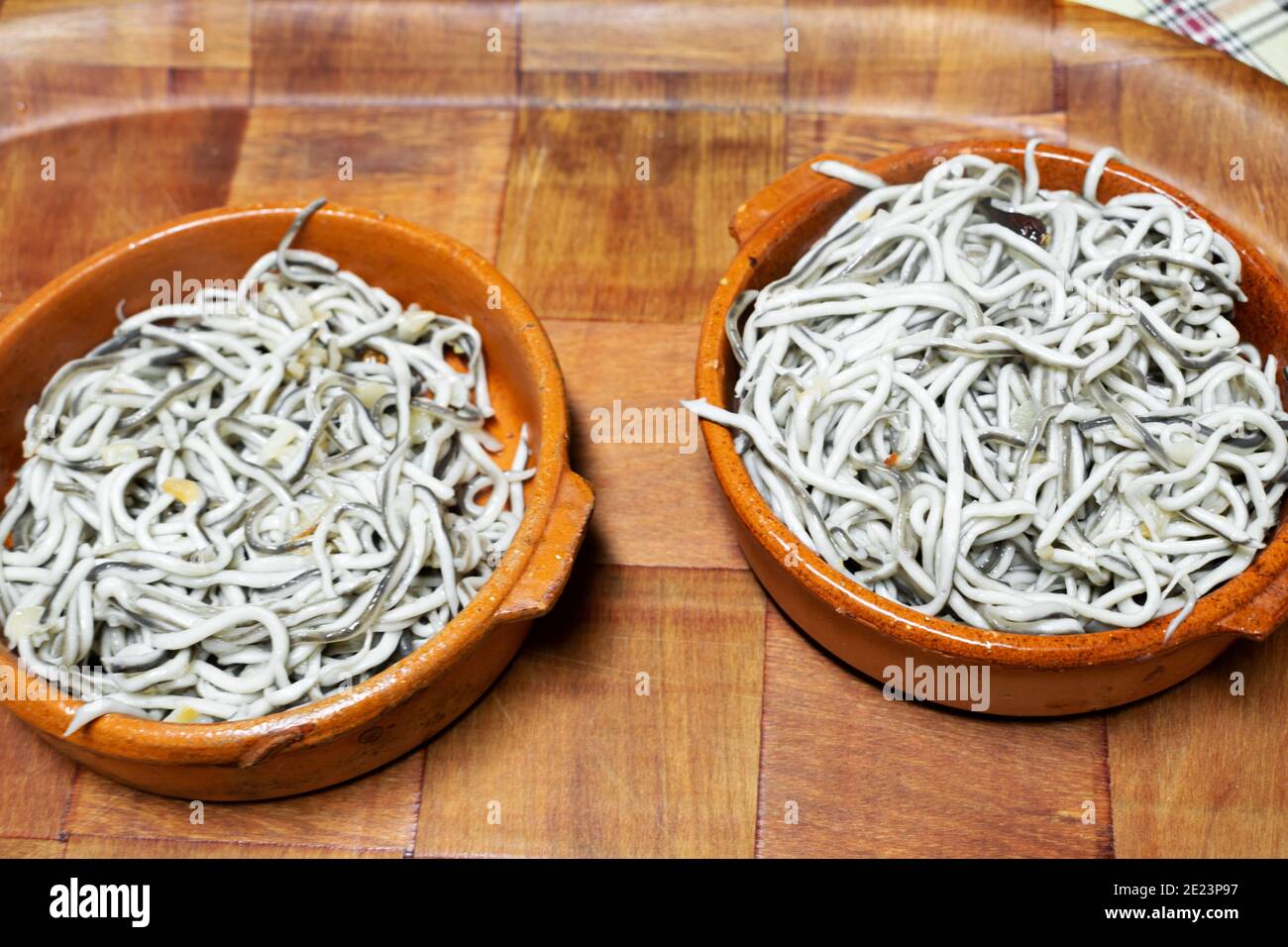Baby eels or substitute for elvers served in a ceramic dish. Typ Stock ...