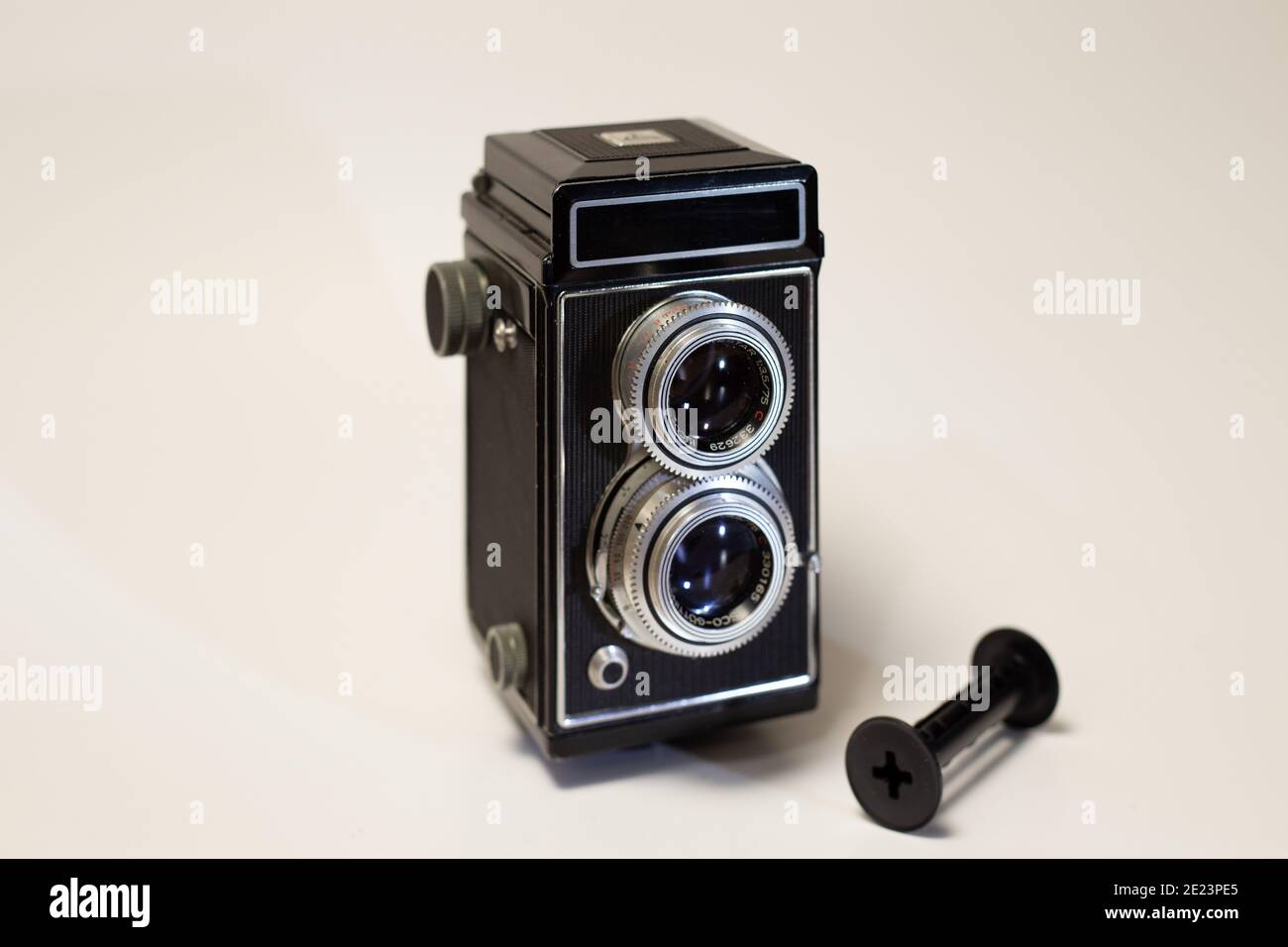Old vintage twin-lens reflex roll-film camera isolated on a white ...