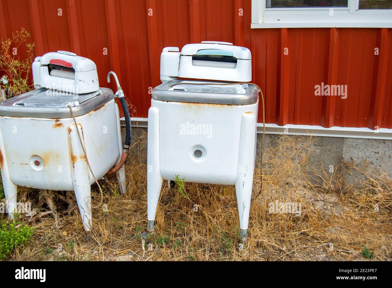 Washing machine in front of metal wall Stock Photo - Alamy