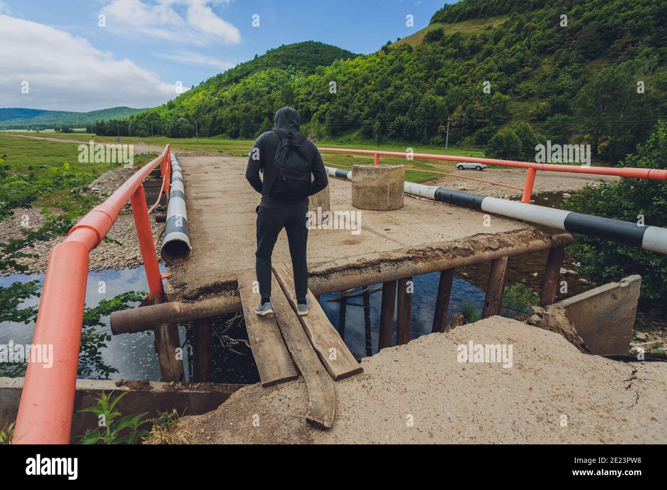 Businessman rebuilding a broken bridge. a man crosses a broken bridge ...